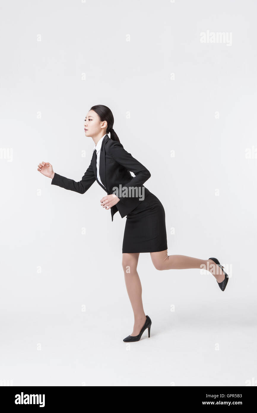 Running businesswoman hi-res stock photography and images - Alamy