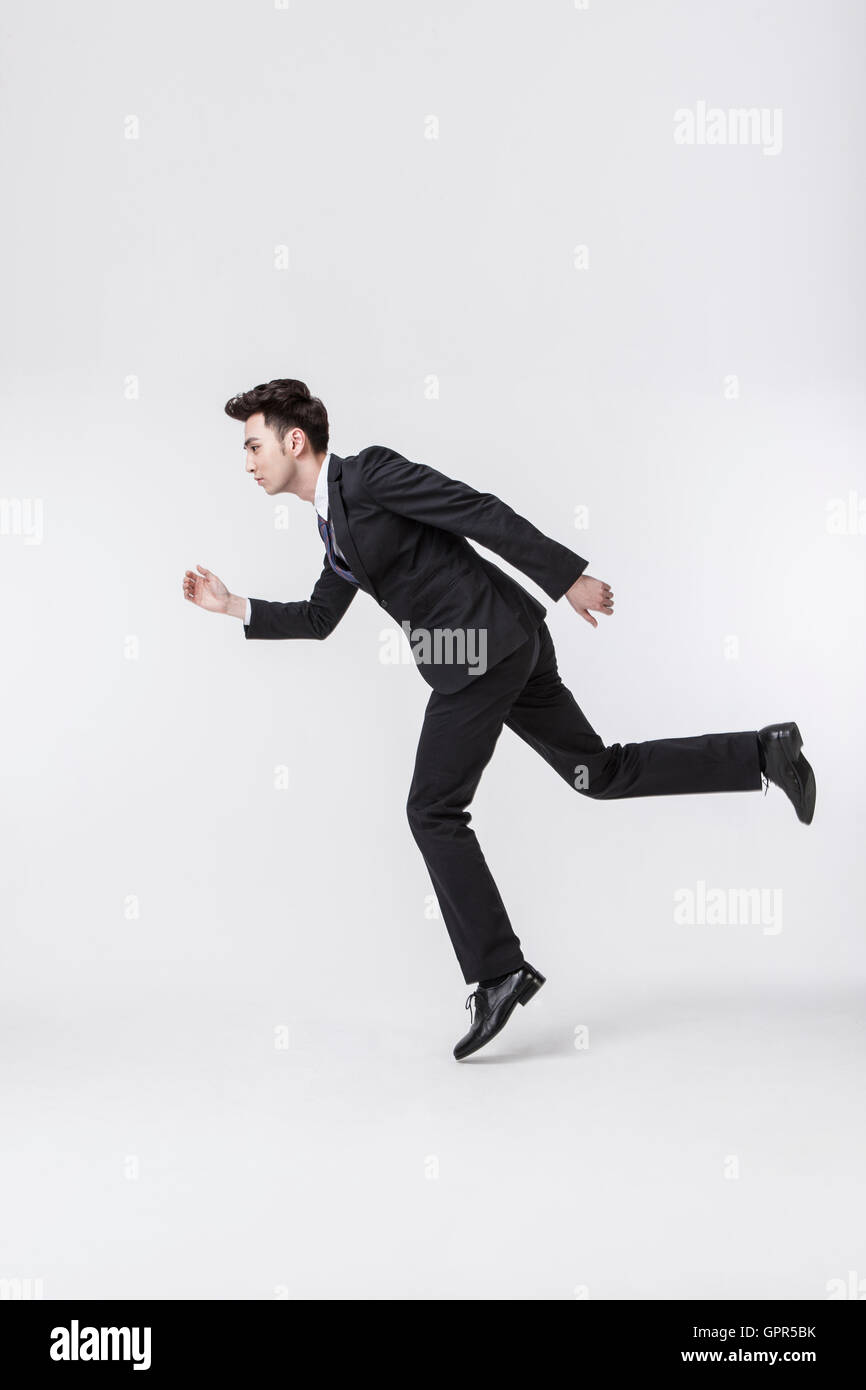 Side view of businessman running Stock Photo - Alamy