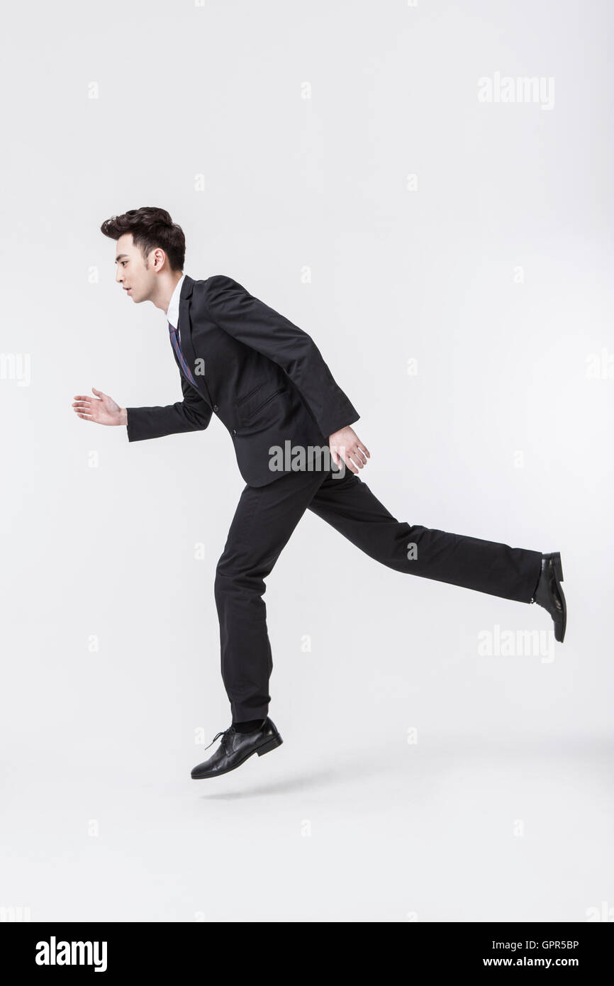 Side view of businessman running Stock Photo - Alamy