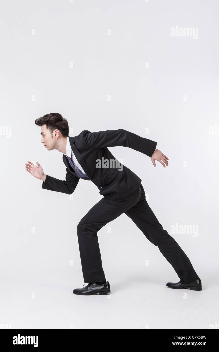 Side view of businessman running Stock Photo - Alamy