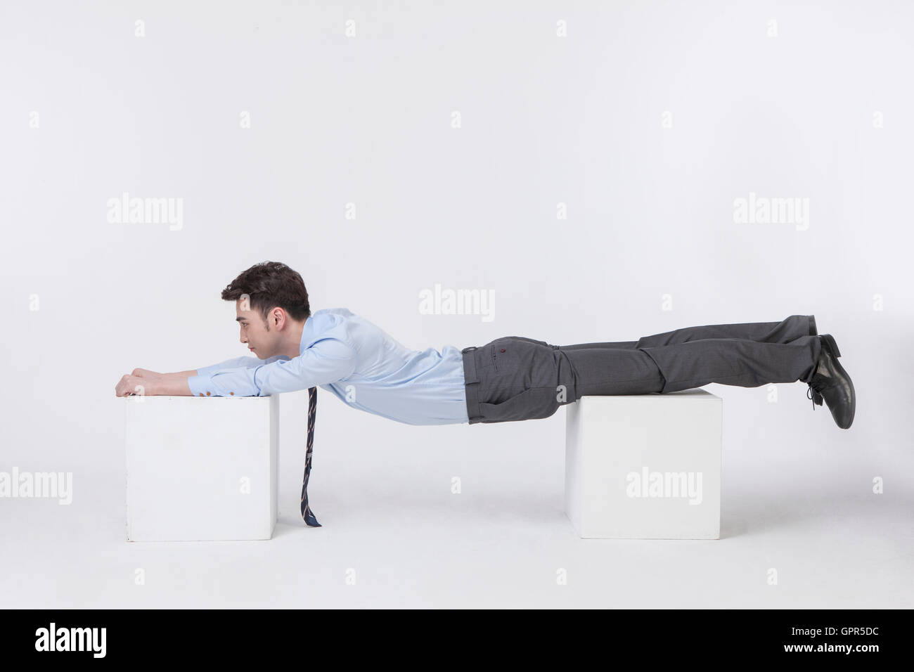 Side view of businessman lying face down Stock Photo - Alamy