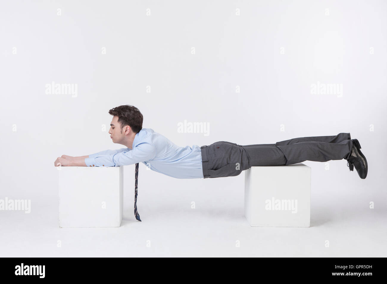 Side view of businessman lying face down Stock Photo - Alamy