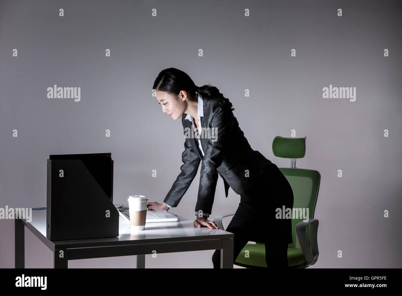 Side view of businesswoman working overtime at night Stock Photo - Alamy