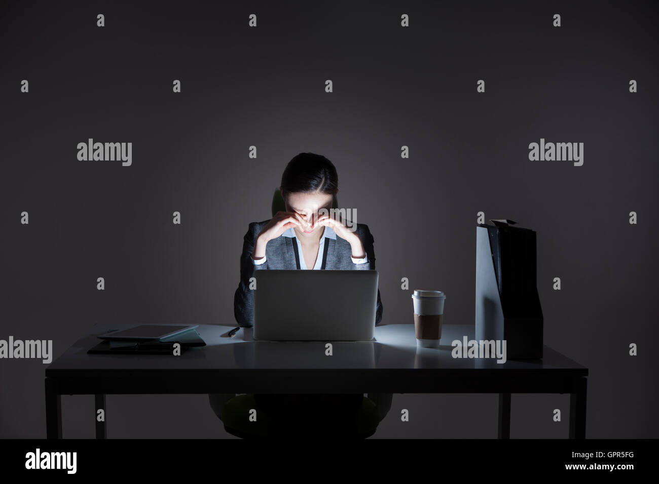 Businesswoman working overtime at night Stock Photo - Alamy
