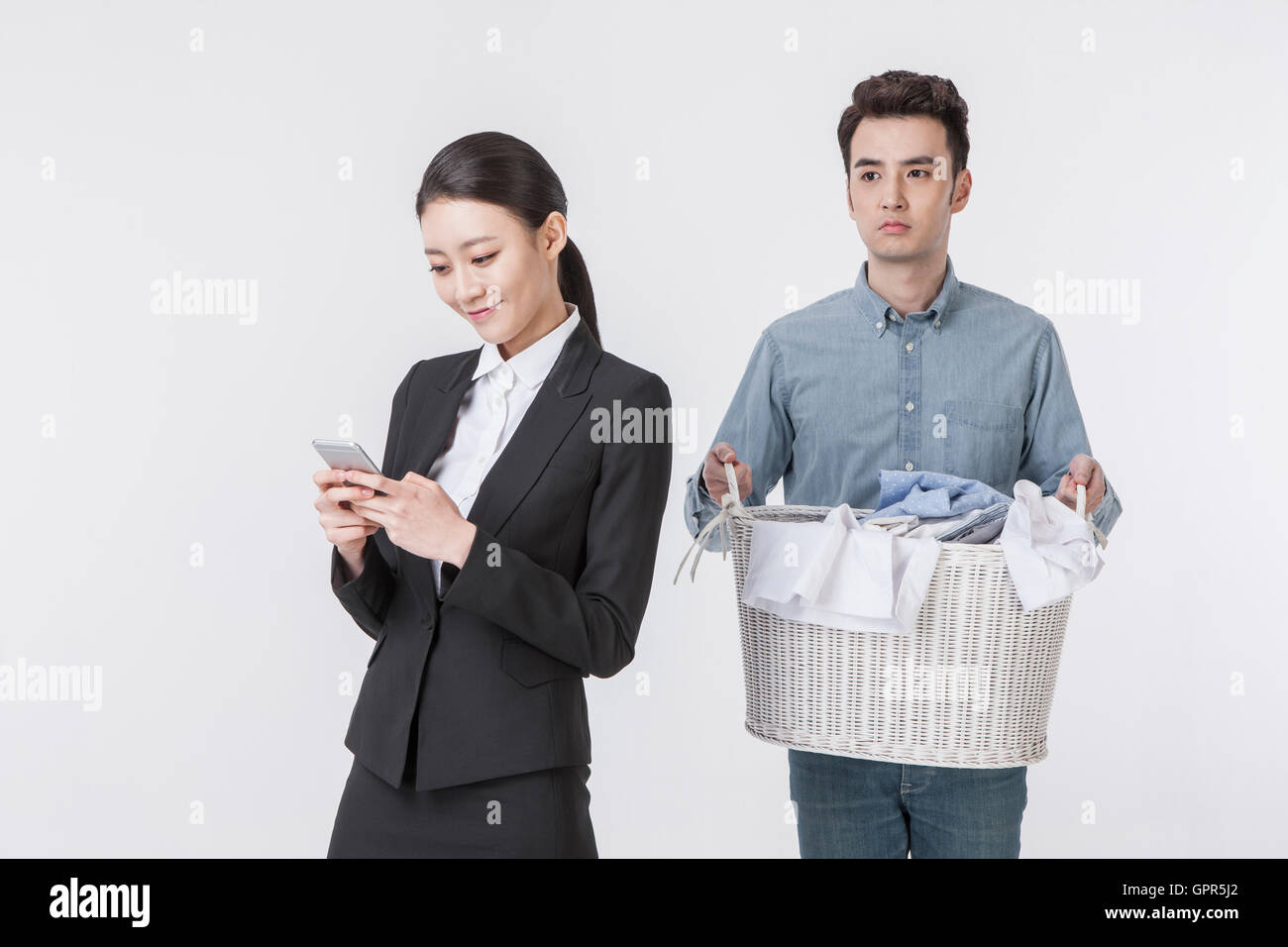 Role reversal of young couple Stock Photo - Alamy