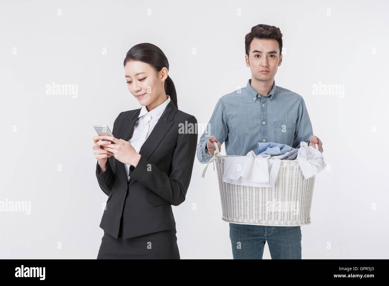 Role reversal of young couple Stock Photo - Alamy