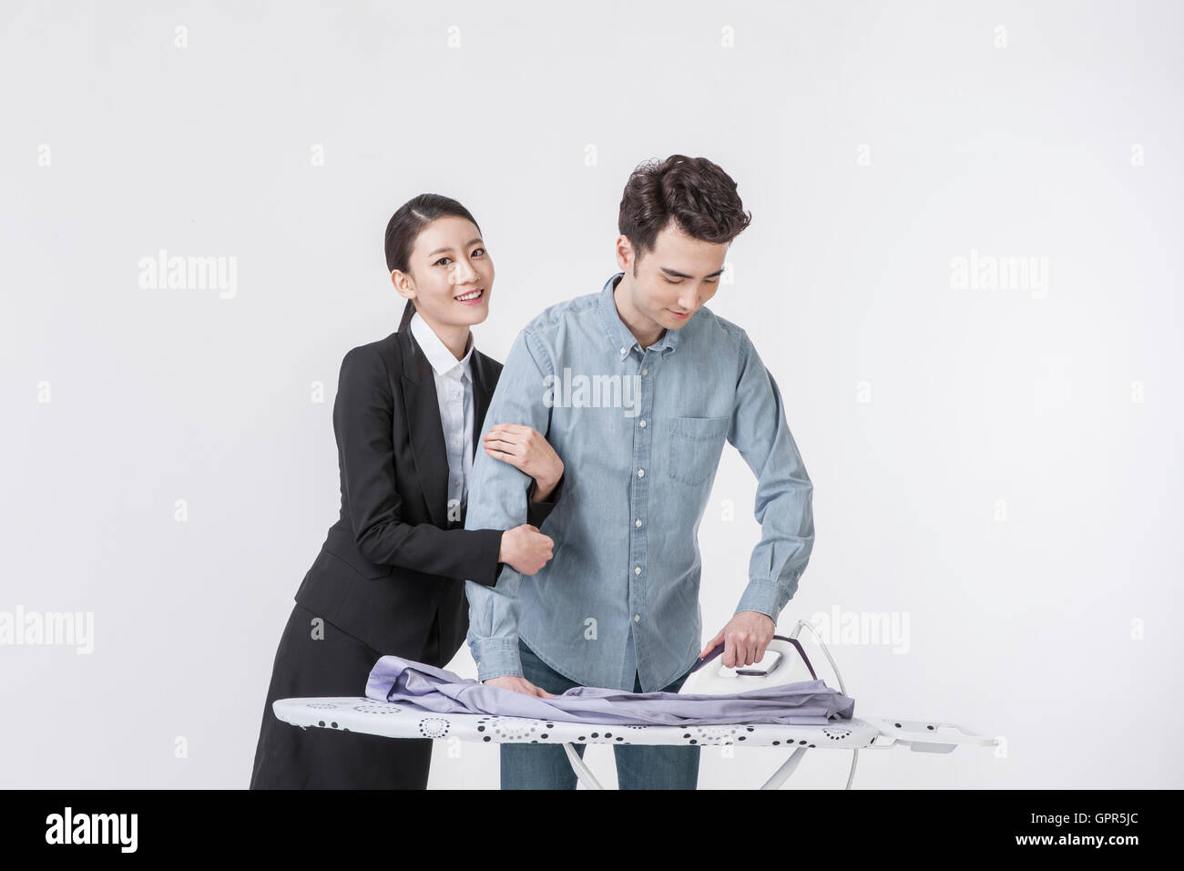 Role reversal of harmonious young couple Stock Photo - Alamy
