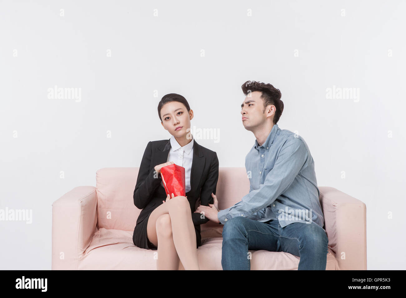Role reversal of young couple Stock Photo - Alamy