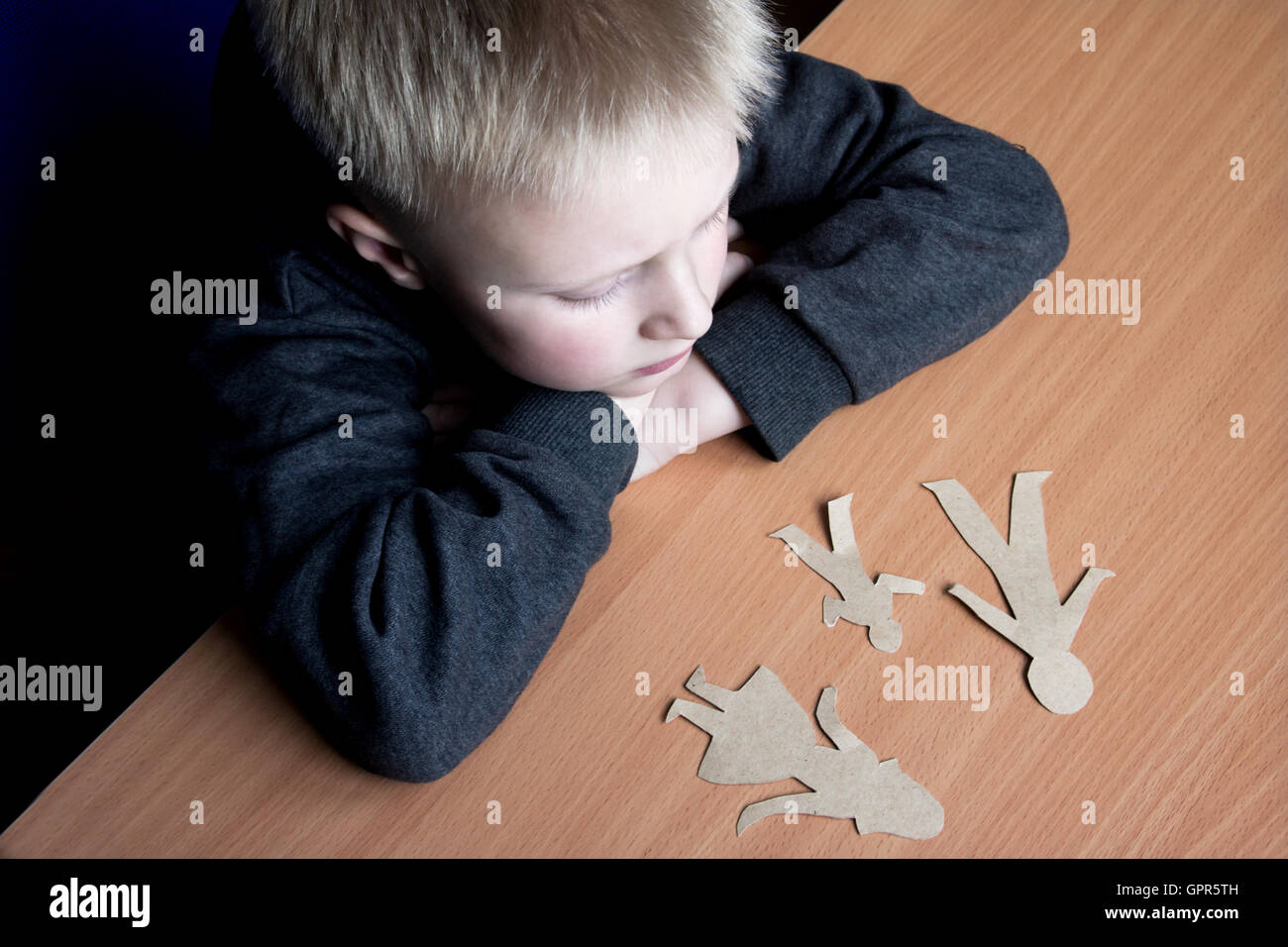 Confused child with broken paper family, family problems, divorce ...