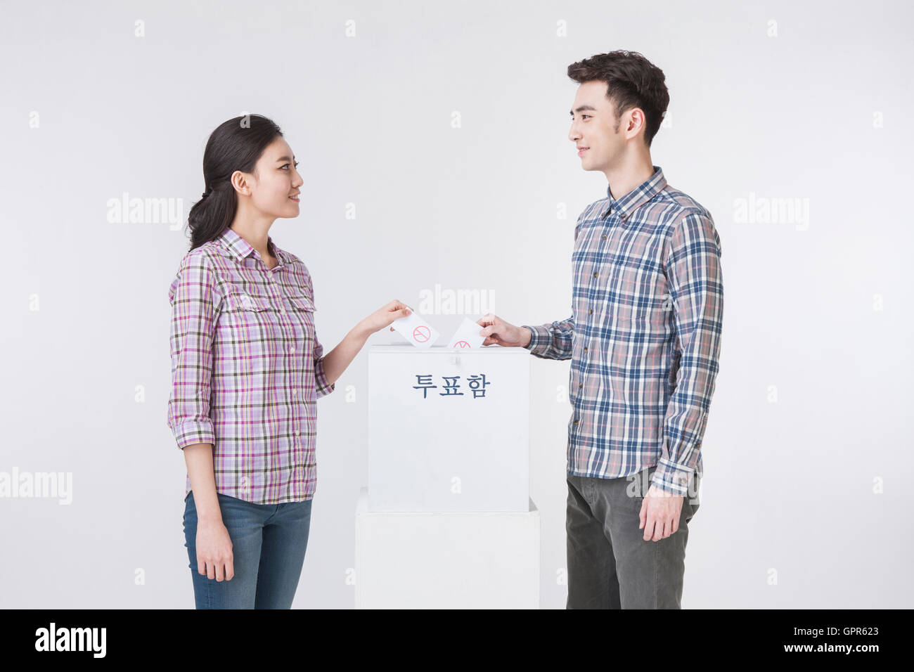 Young man and young woman taking votes Stock Photo - Alamy