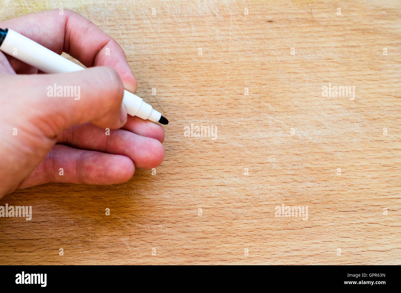 Human hand over wooden background and place for text Stock Photo - Alamy