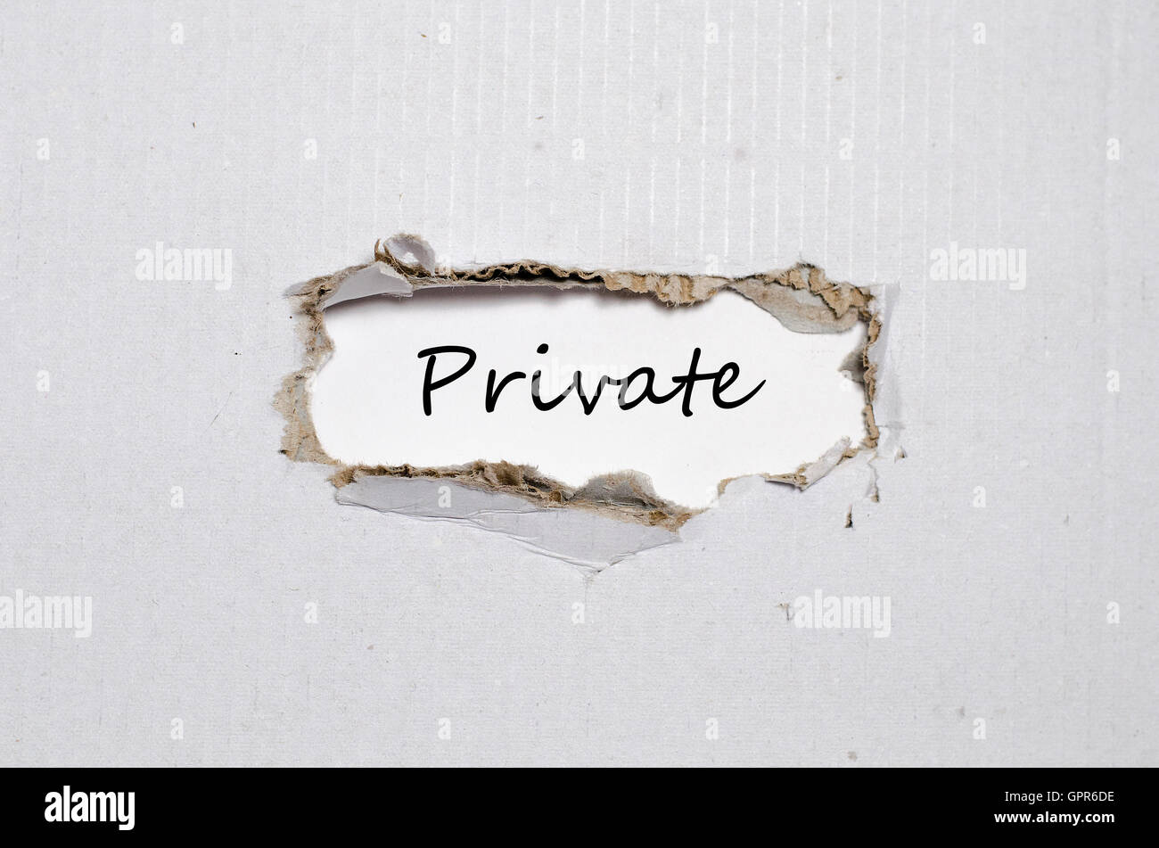 The word private appearing behind torn paper Stock Photo - Alamy