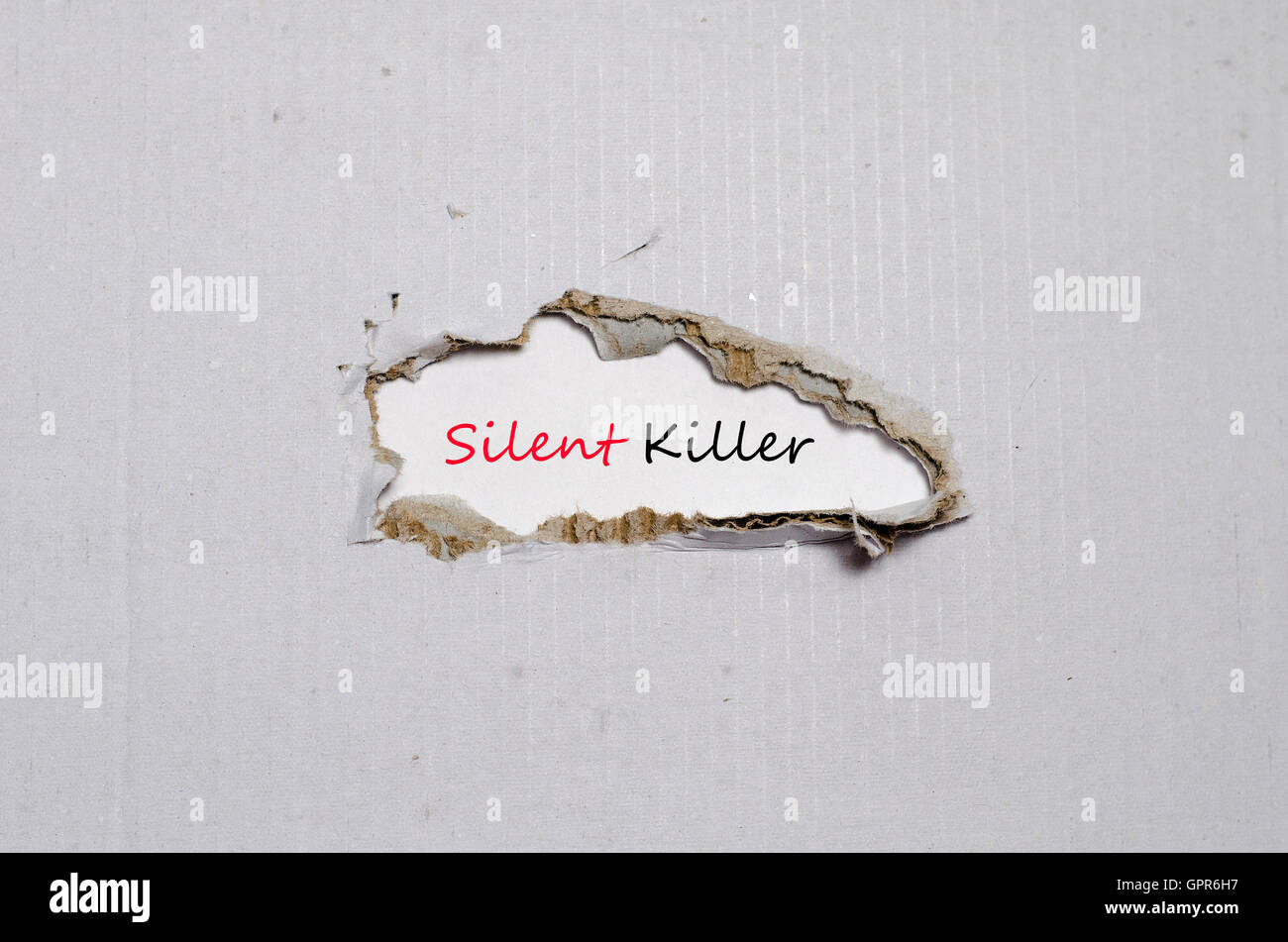 The word silent killer appearing behind torn paper Stock Photo - Alamy