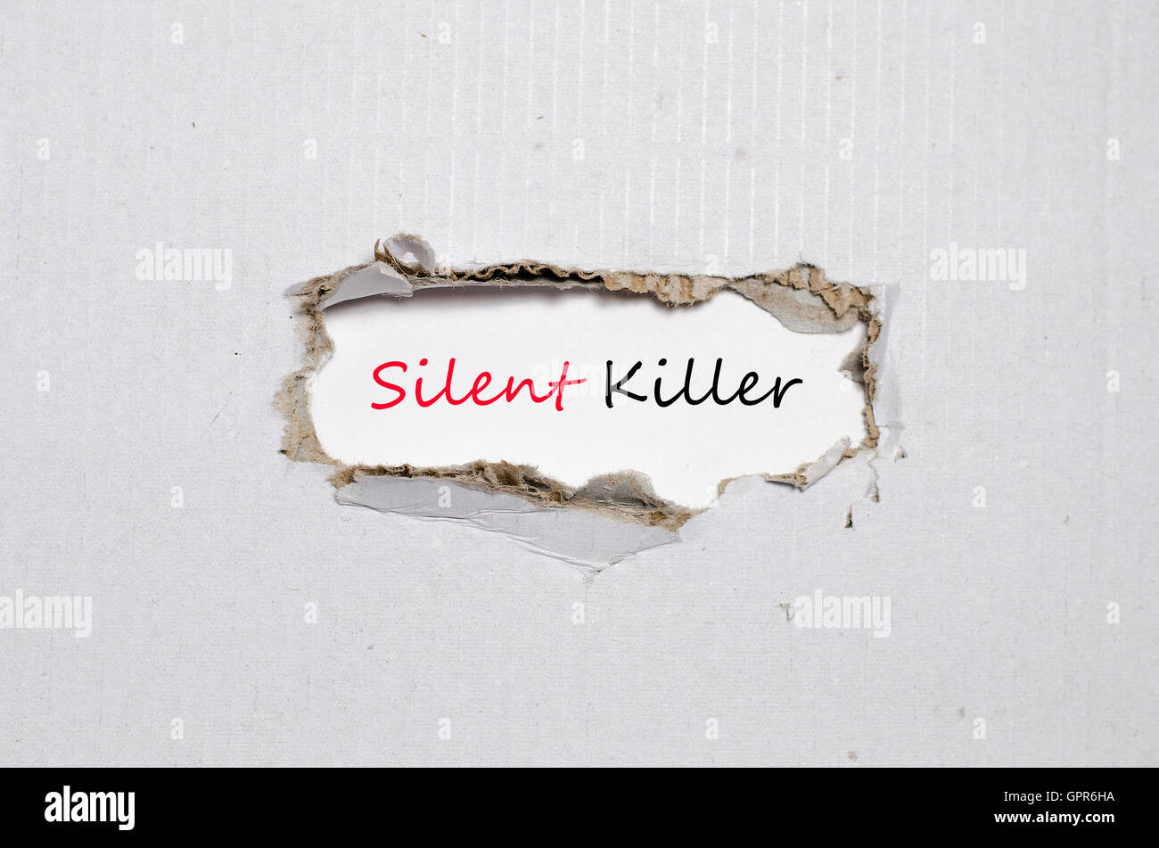 The word silent killer appearing behind torn paper Stock Photo - Alamy