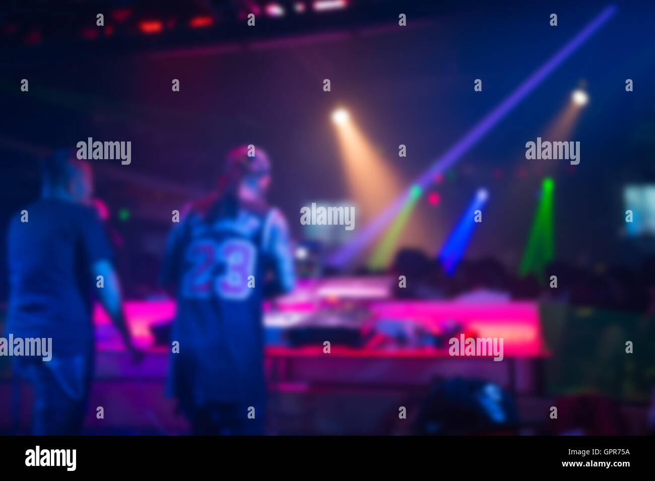 Blurred background : Club, disco DJ playing and mixing music for crowd ...