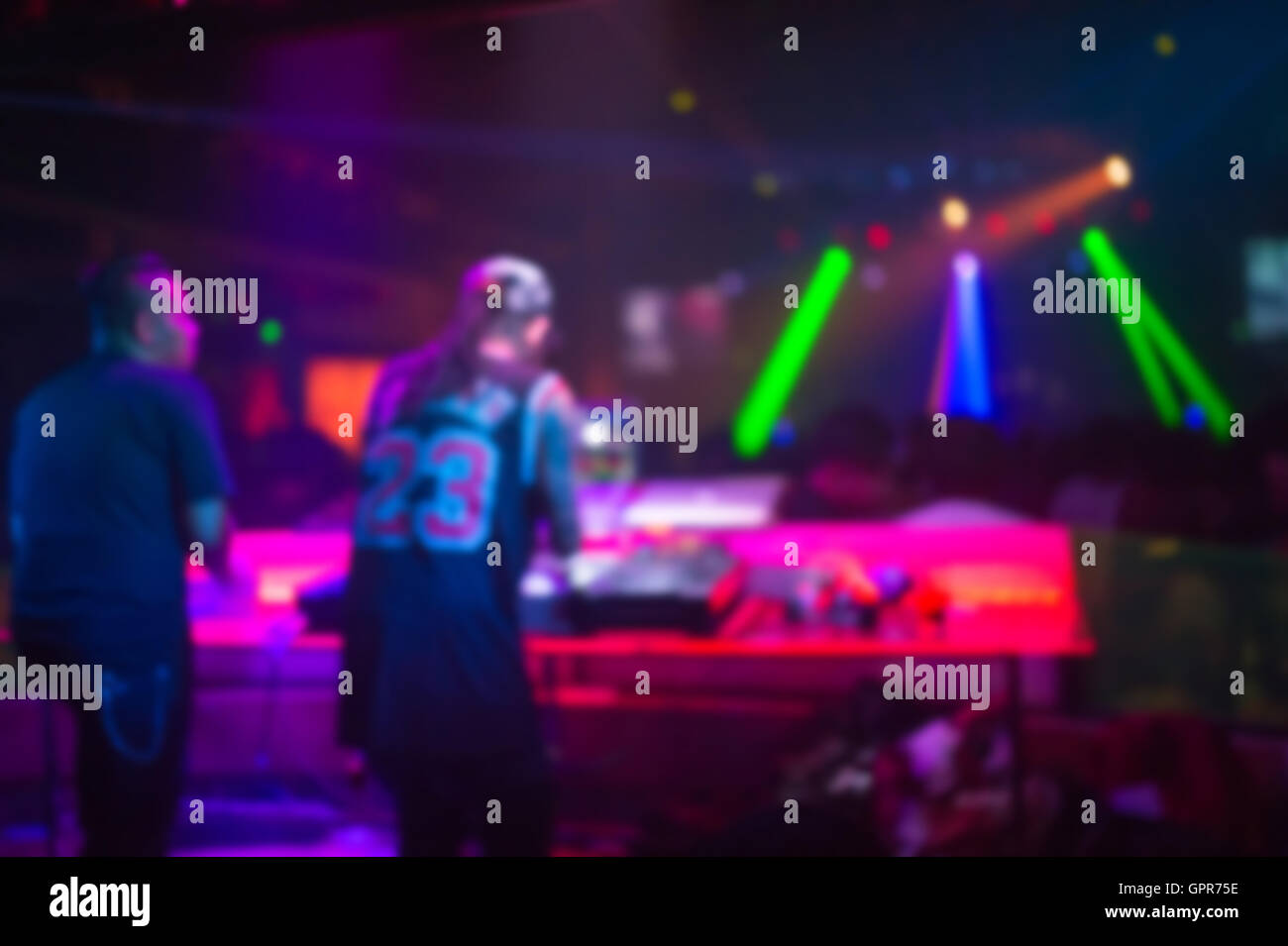 Blurred background : Club, disco DJ playing and mixing music for crowd ...