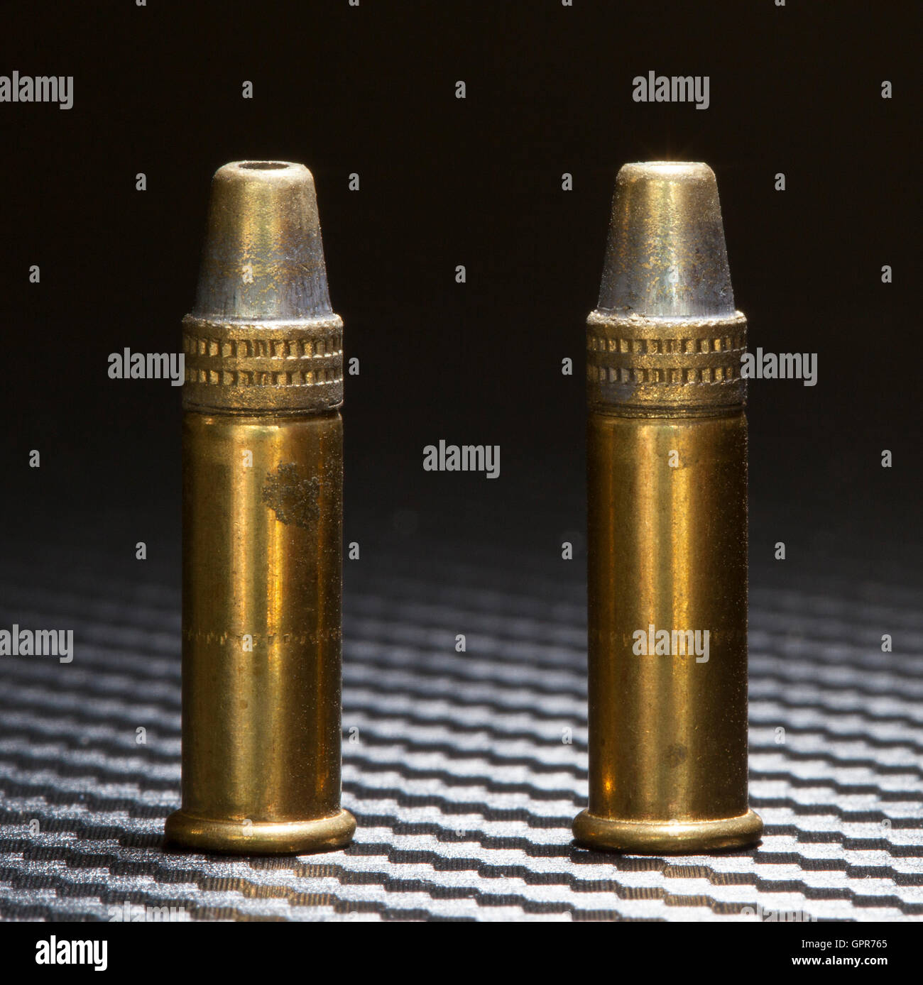 Two rim fire cartridges on a graphite background Stock Photo - Alamy