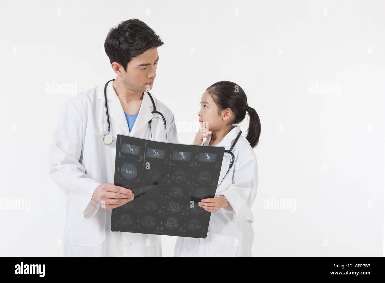 Doctor teaching his daughter medicine Stock Photo - Alamy