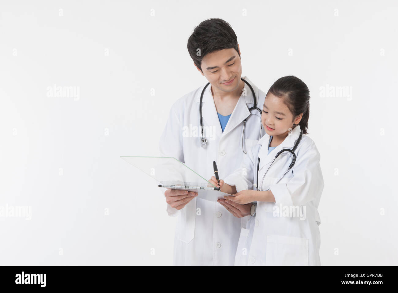 Doctor teaching his daughter medicine Stock Photo - Alamy