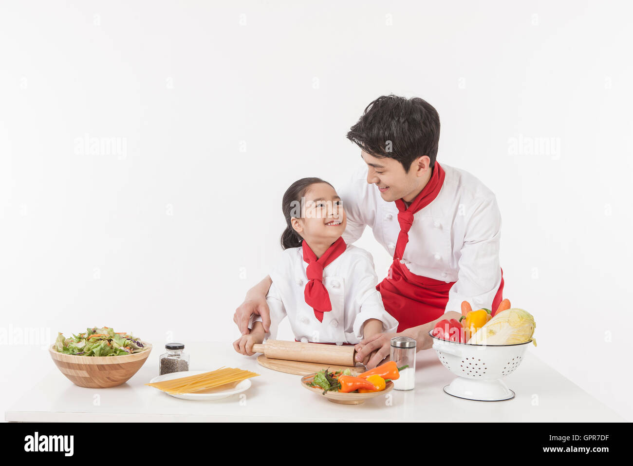 Smiling father and daughter cooking Stock Photo - Alamy