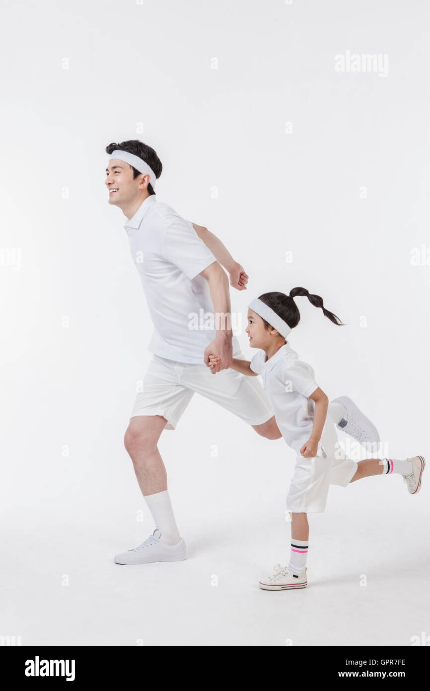 Loving father and daughter running hand in hand Stock Photo - Alamy
