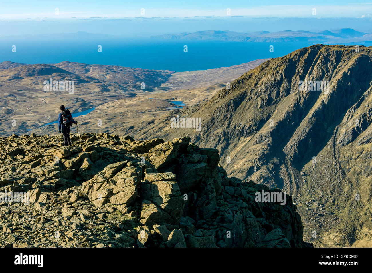A walker on the summit ridge of Trollabhal in the Rum Cuillin hills ...
