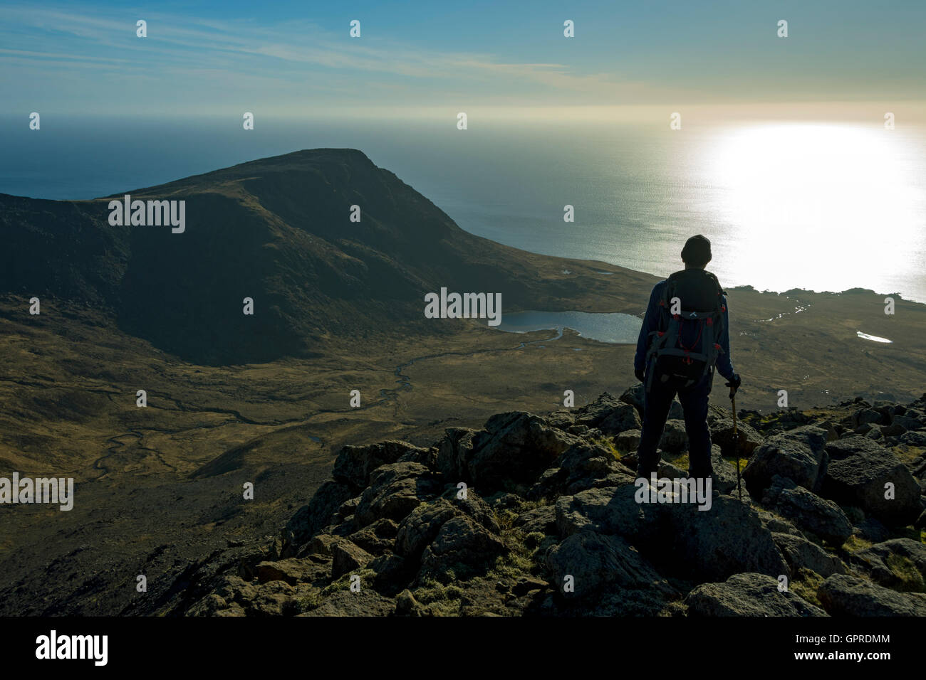 A walker on the summit ridge of Trollabhal in the Rum Cuillin hills ...