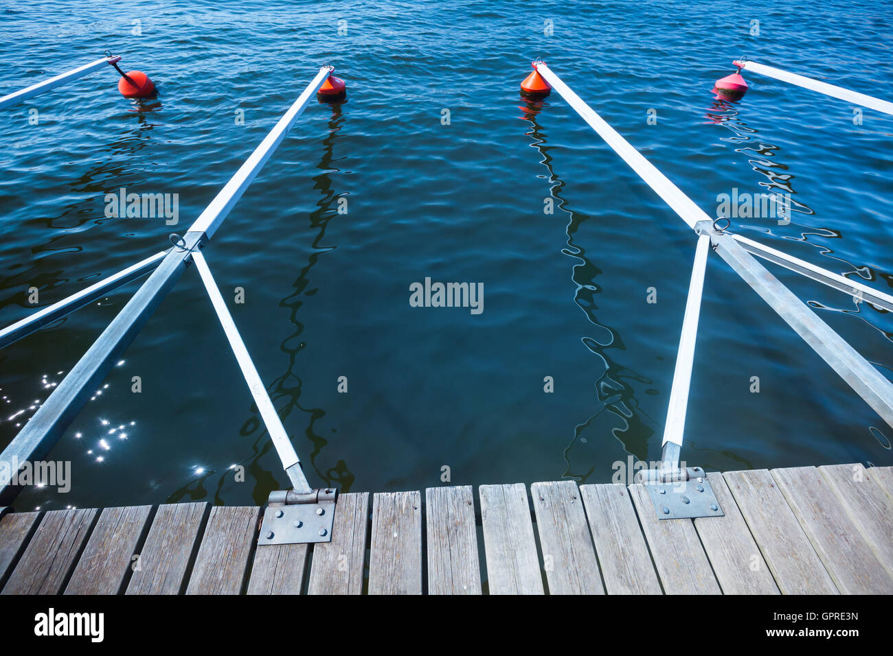 Red mooring buoys in a row floating on blue water, marina port ...