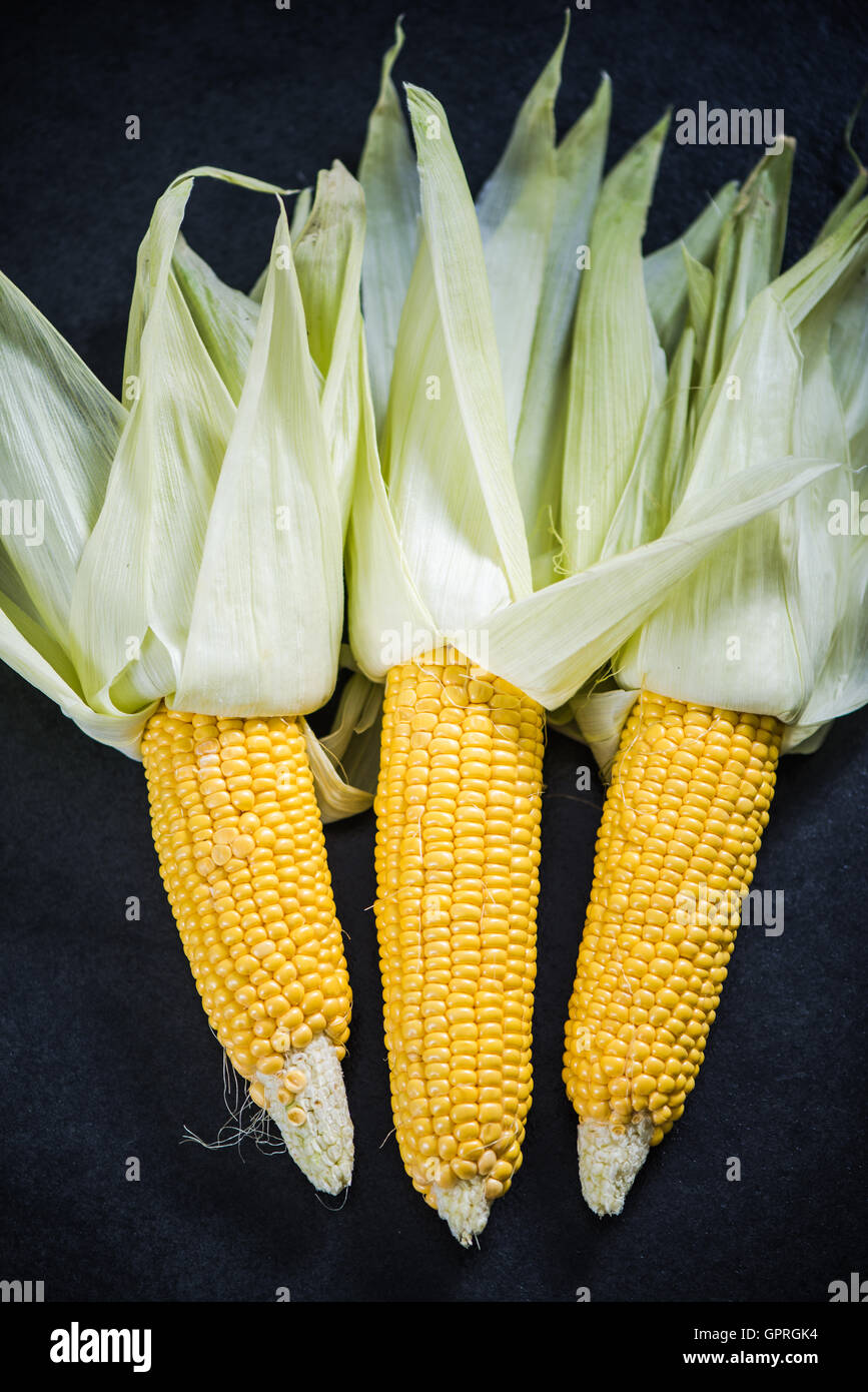 whole corn cobs on dark slate Stock Photo - Alamy