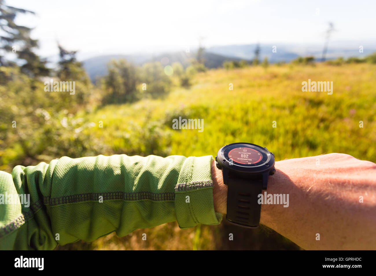 Hiker or traveler on mountain trail checking direction on electronic ...