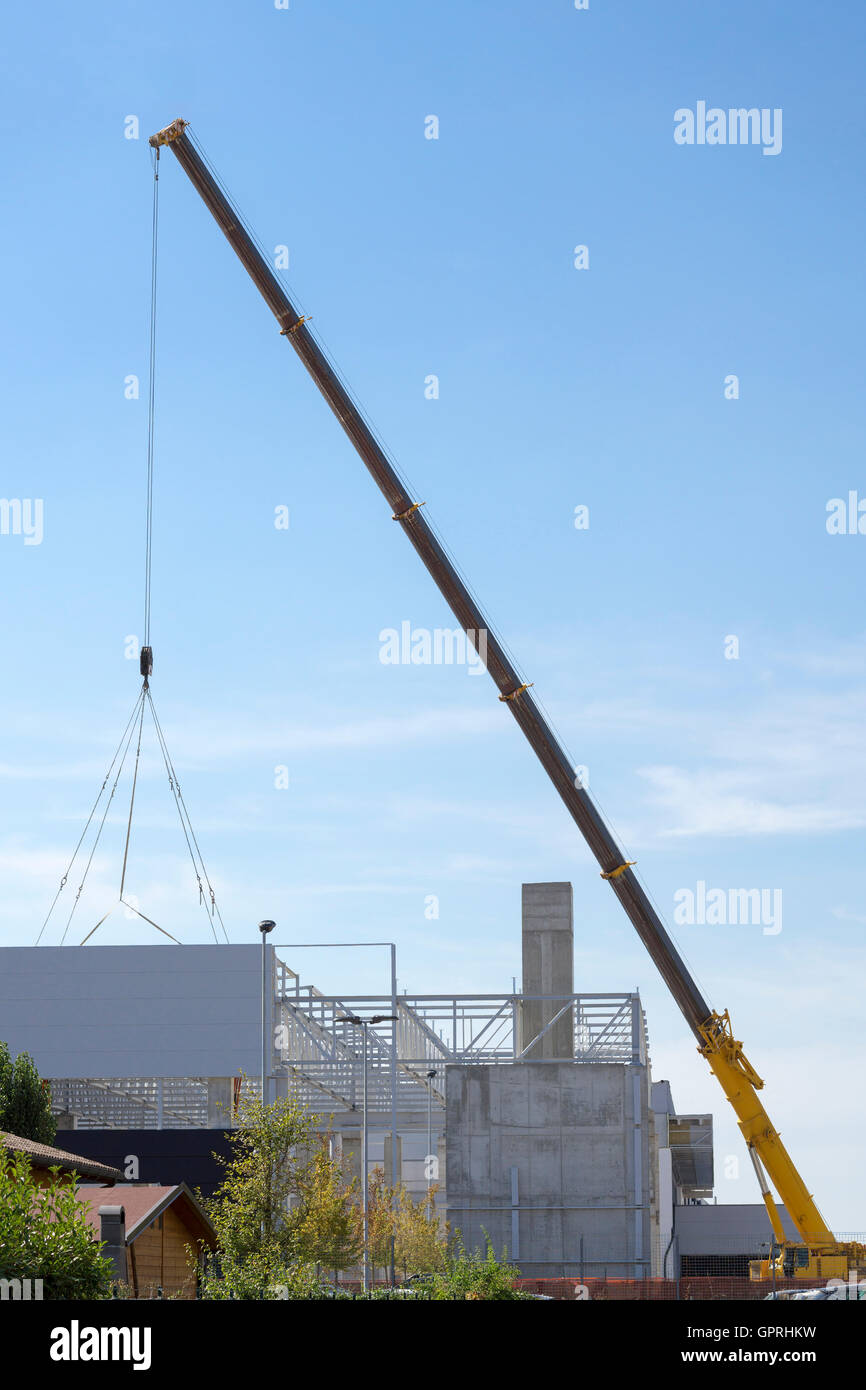 crane in motion for the construction of an industrial warehouse Stock ...