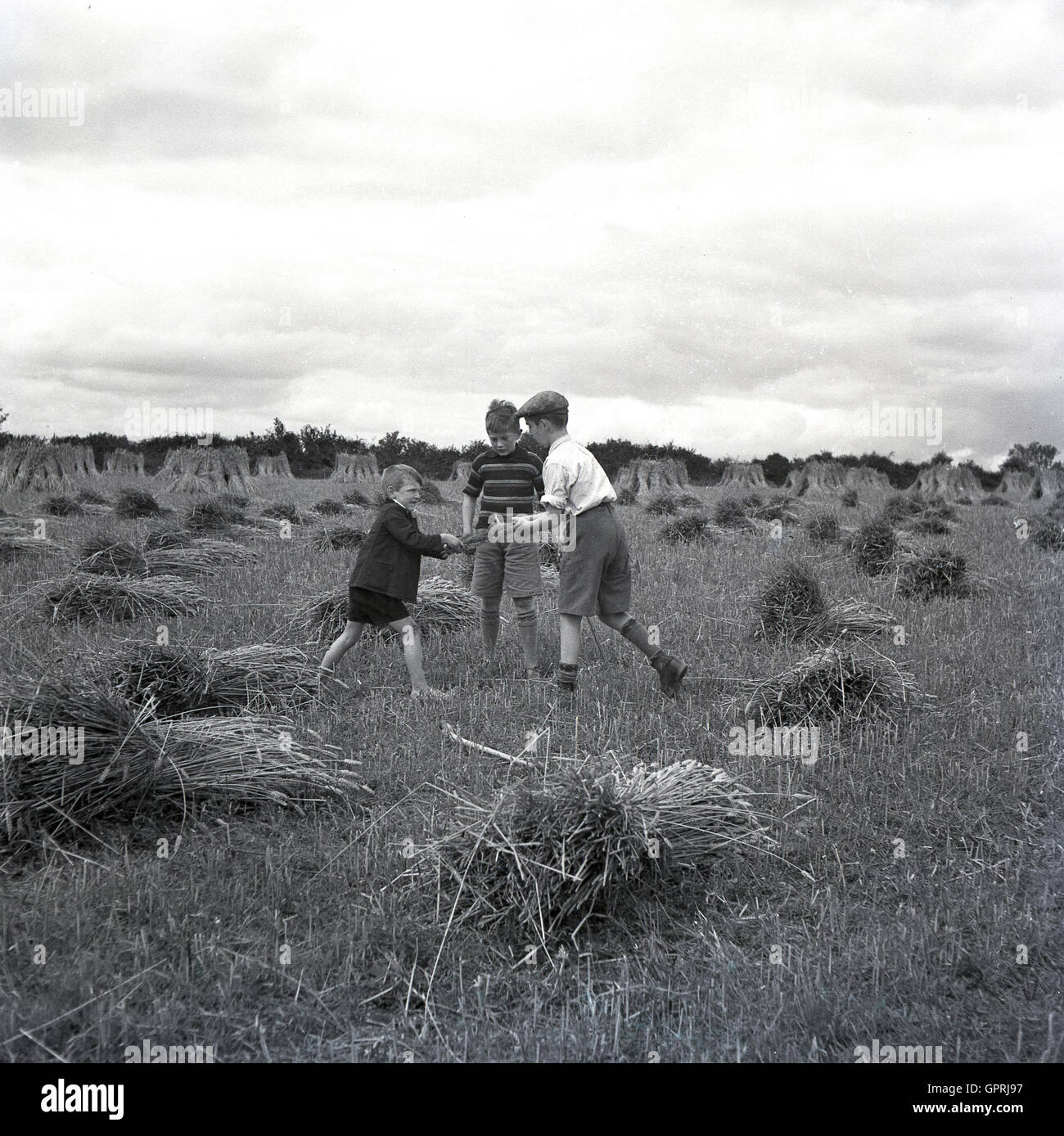 1930s, historical, 'it's my rabbit', two young boys pulling a rabbit in ...