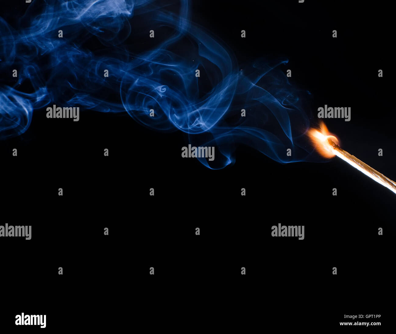 Match ignition with smoke over black background Stock Photo - Alamy