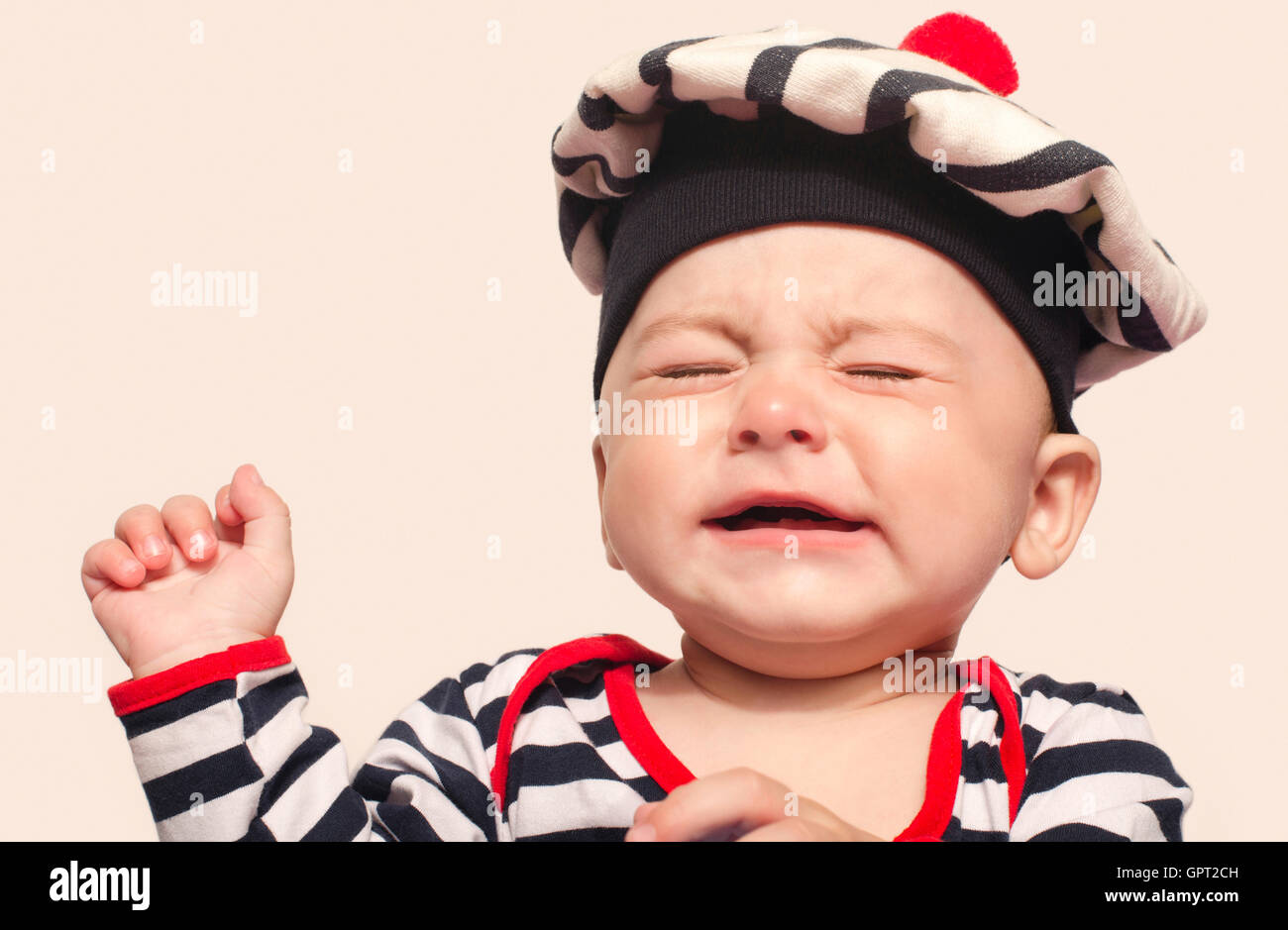 Cute baby boy crying raising his hands up Stock Photo - Alamy