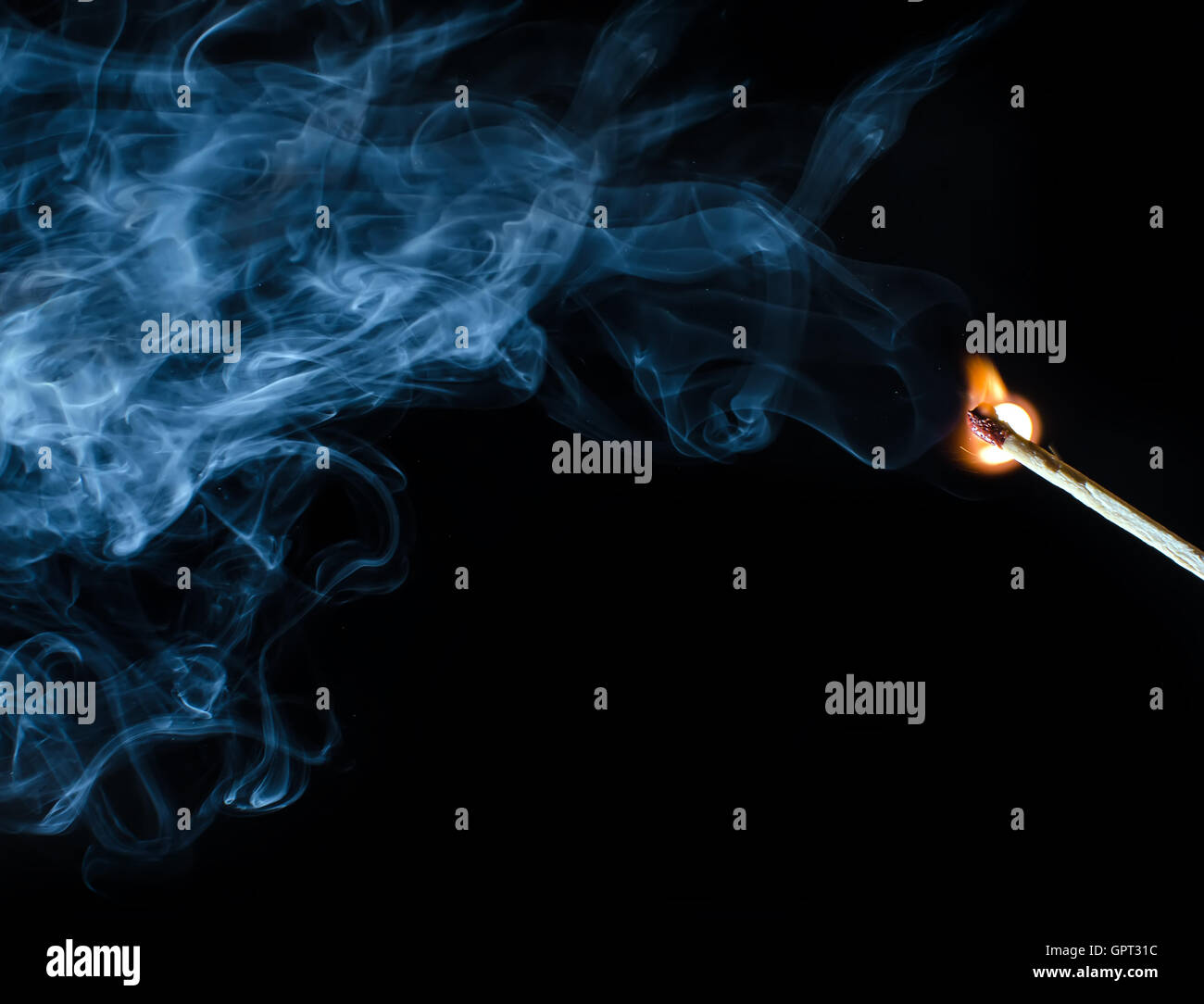 Match ignition with smoke over black background Stock Photo - Alamy