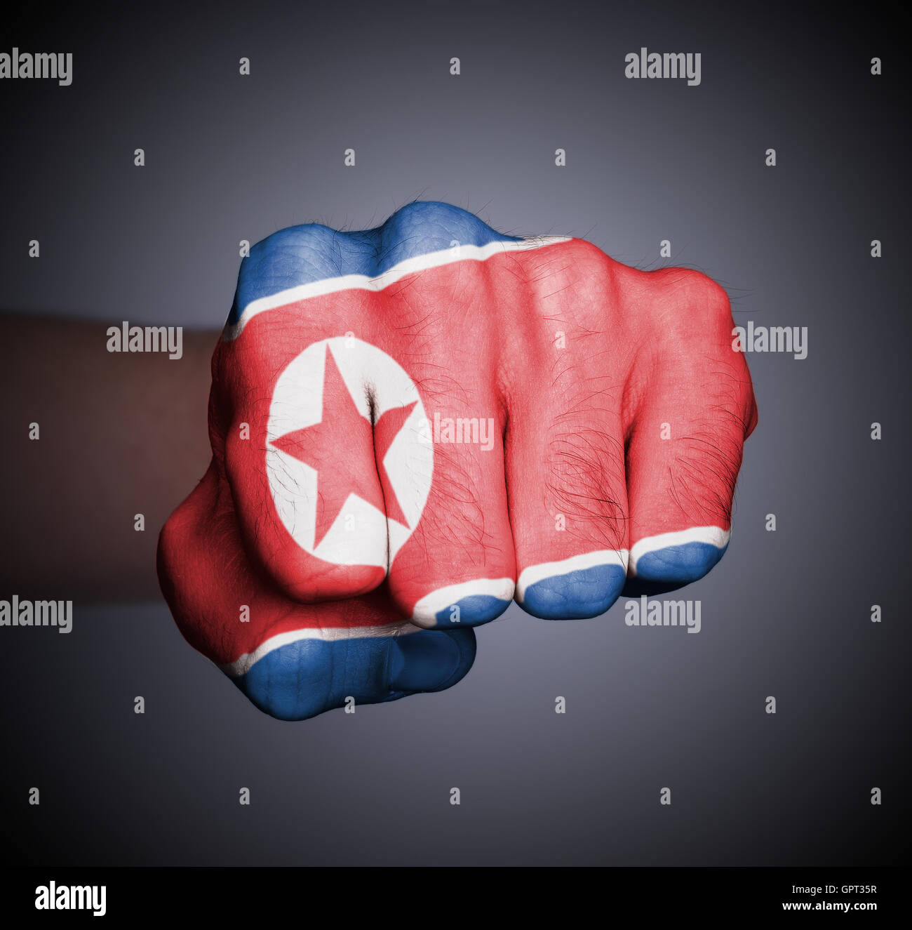 Front view of punching fist on gray background Stock Photo - Alamy