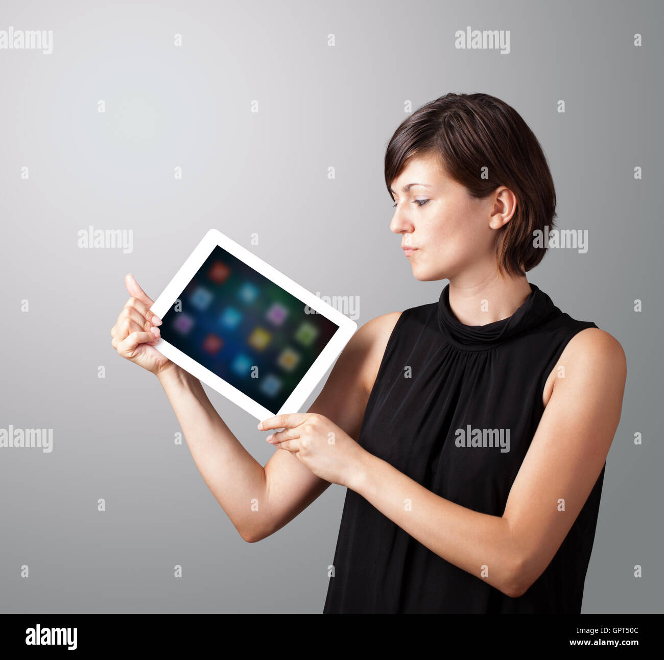 woman holding modern tablet with colorful icons Stock Photo - Alamy