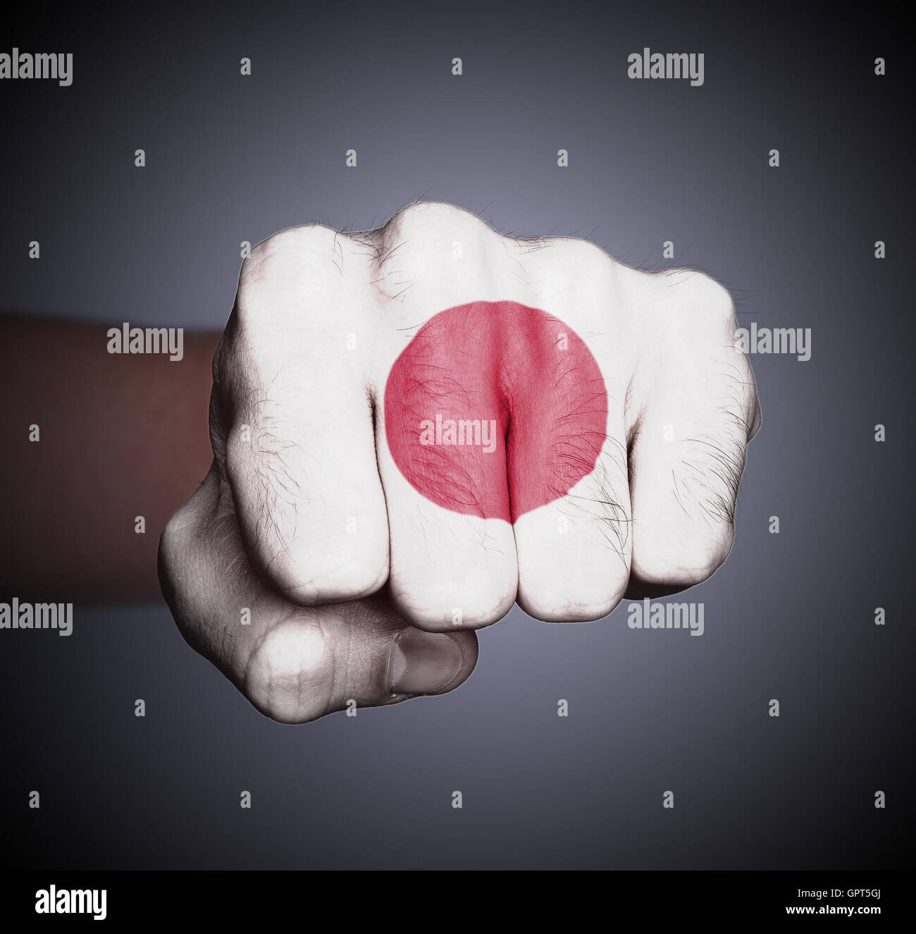 Front view of punching fist on gray background Stock Photo - Alamy