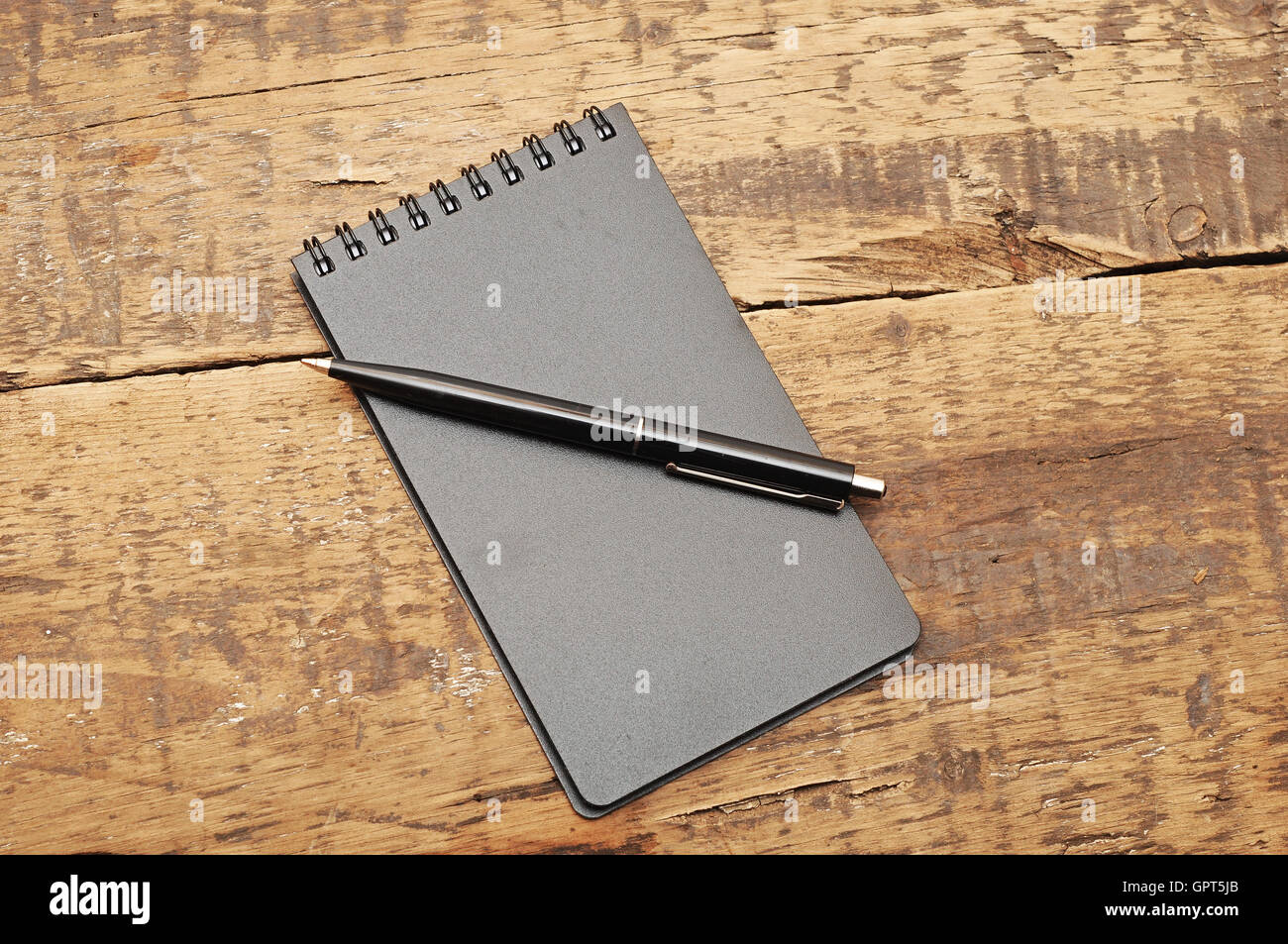 Blank notepad with pen on wood table Stock Photo - Alamy