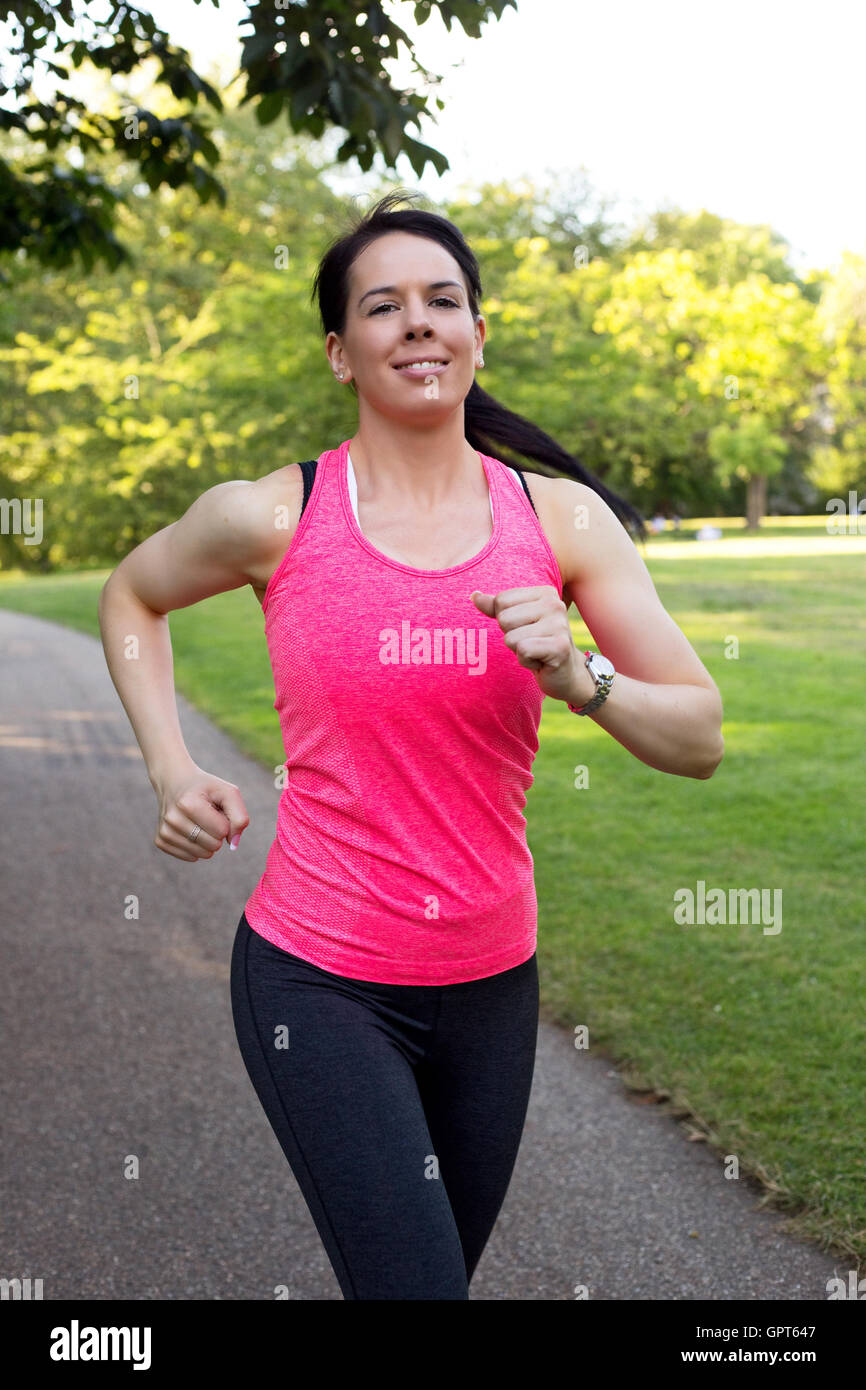 young woman running through the park Stock Photo - Alamy