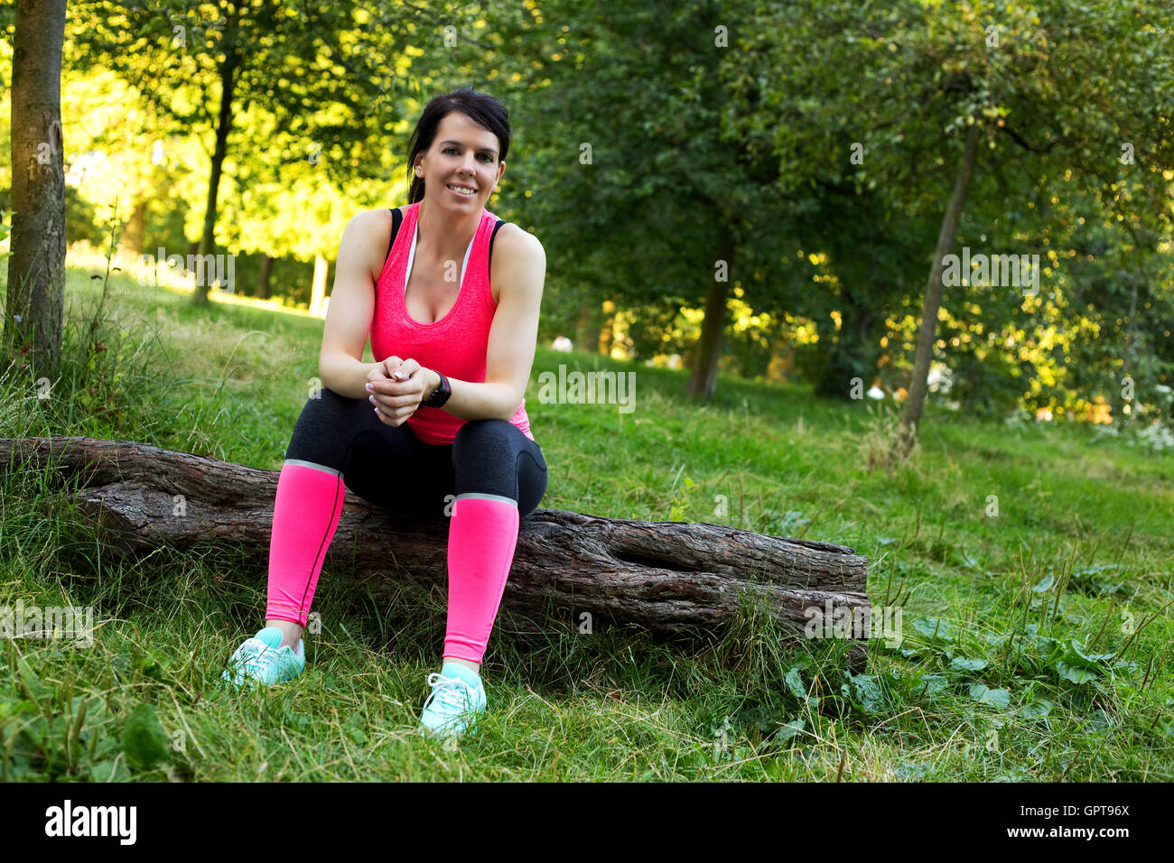 Woman sitting on a log hi-res stock photography and images - Alamy