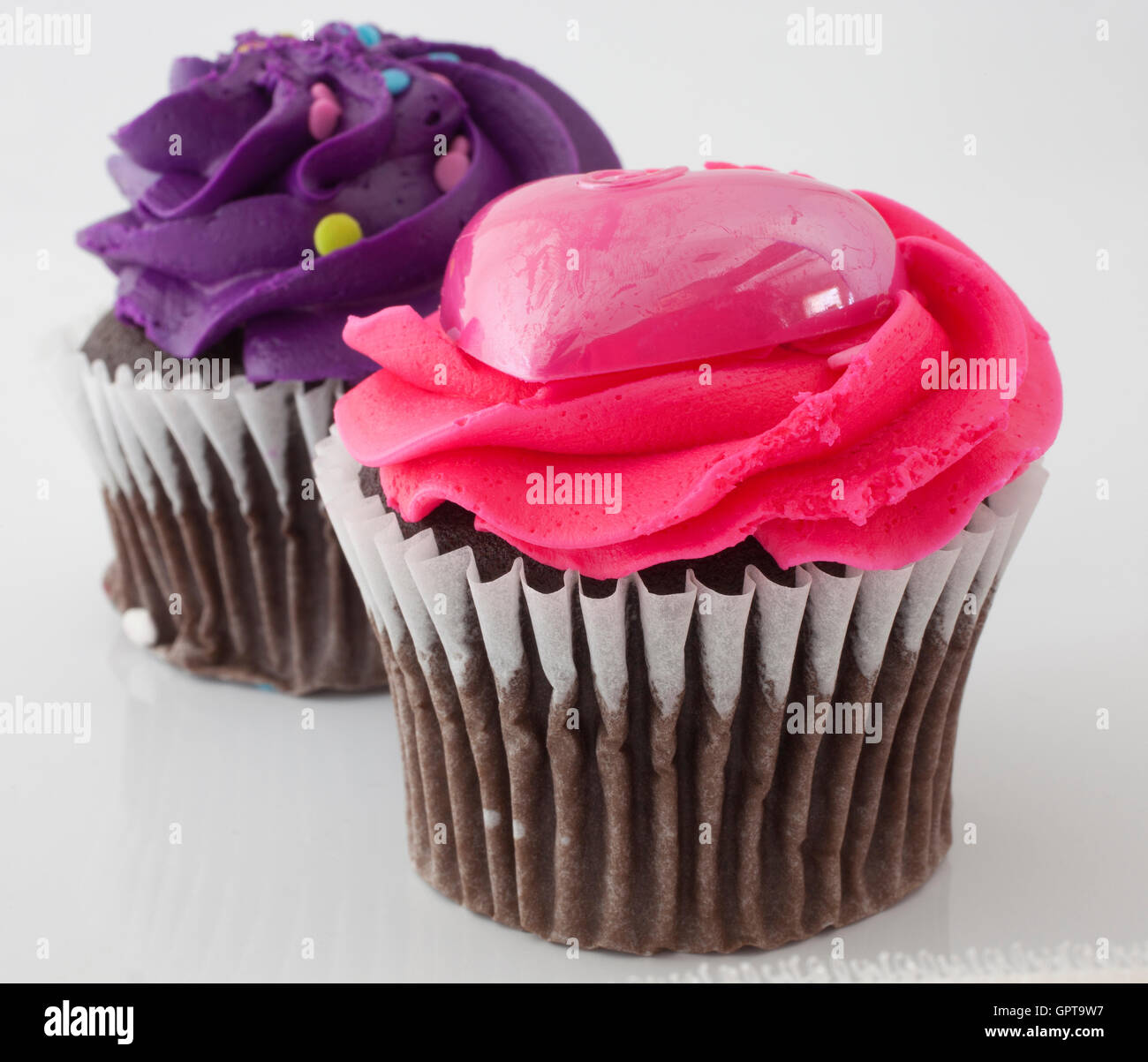 Chocolate cupcakes with pink and purple icing Stock Photo - Alamy
