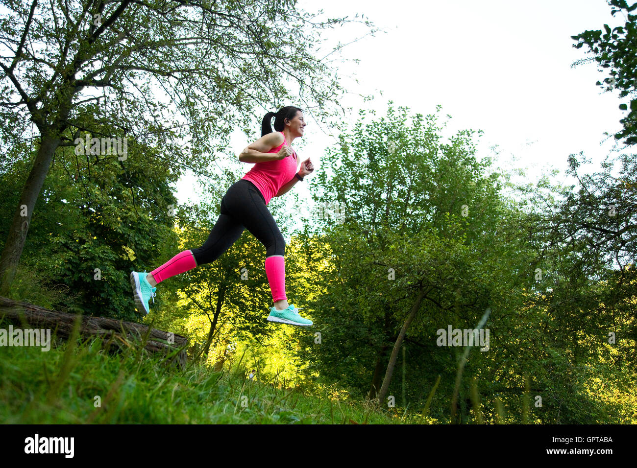 young woman running in nature Stock Photo - Alamy