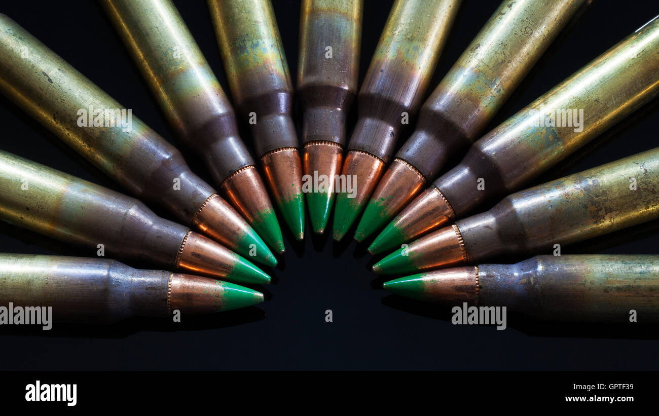 Rifle ammunition that has green tipped bullets in a semi circle on ...