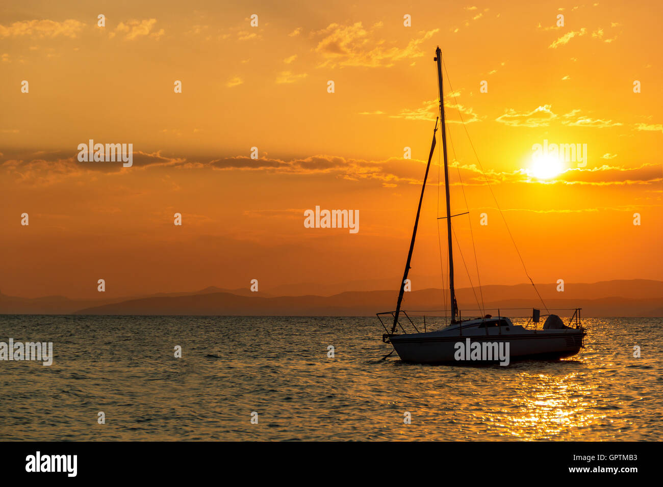 A beautiful sunset and a boat on the beach Stock Photo - Alamy
