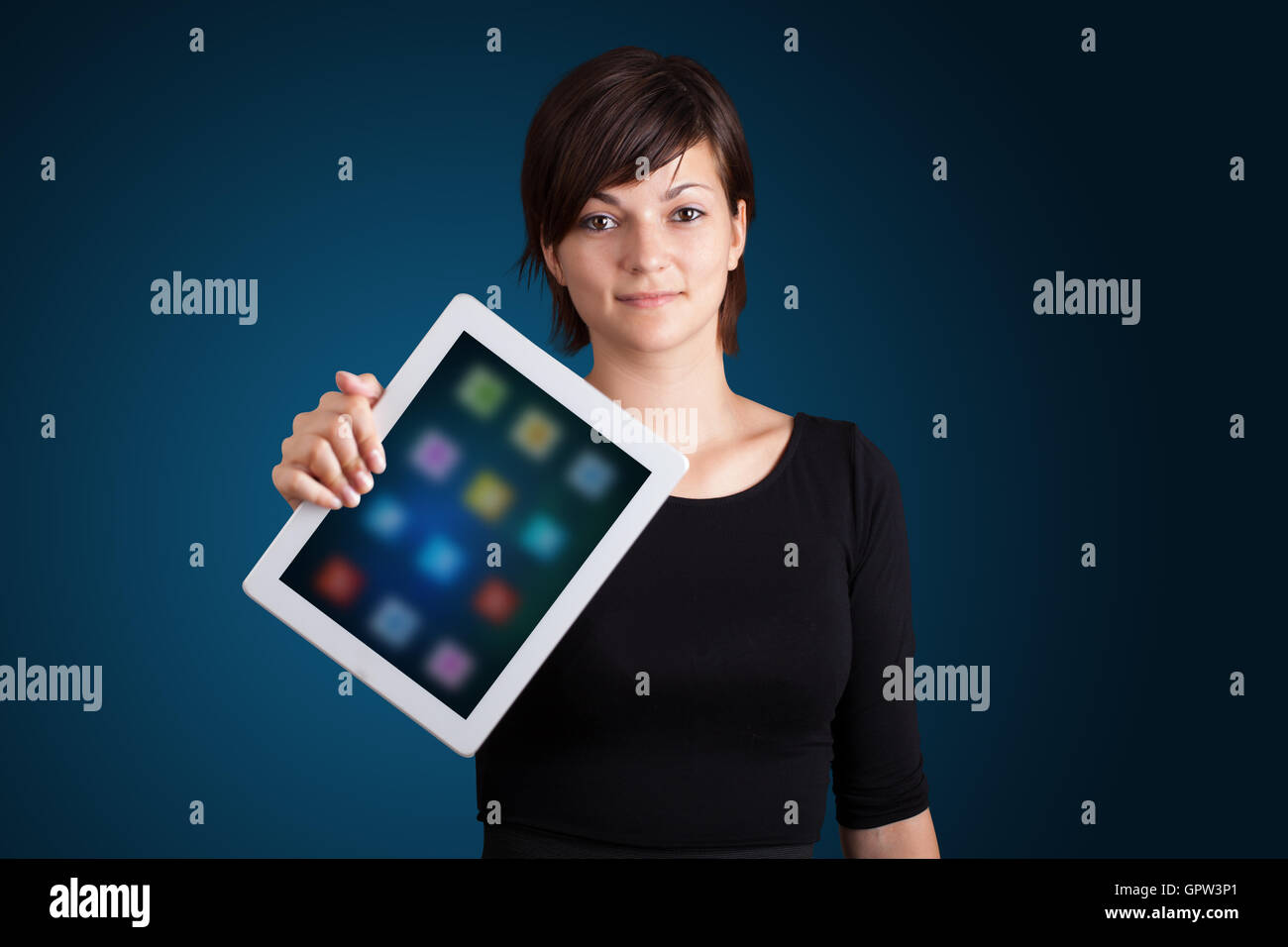 woman holding modern tablet with colorful icons Stock Photo - Alamy