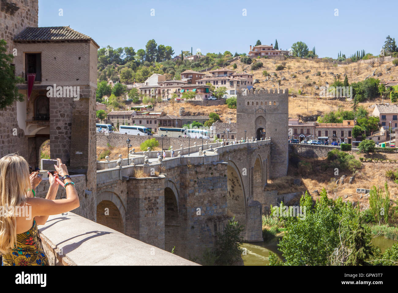 Tourist taking pictures to Saint Martin medieval bridge in Toledo ...