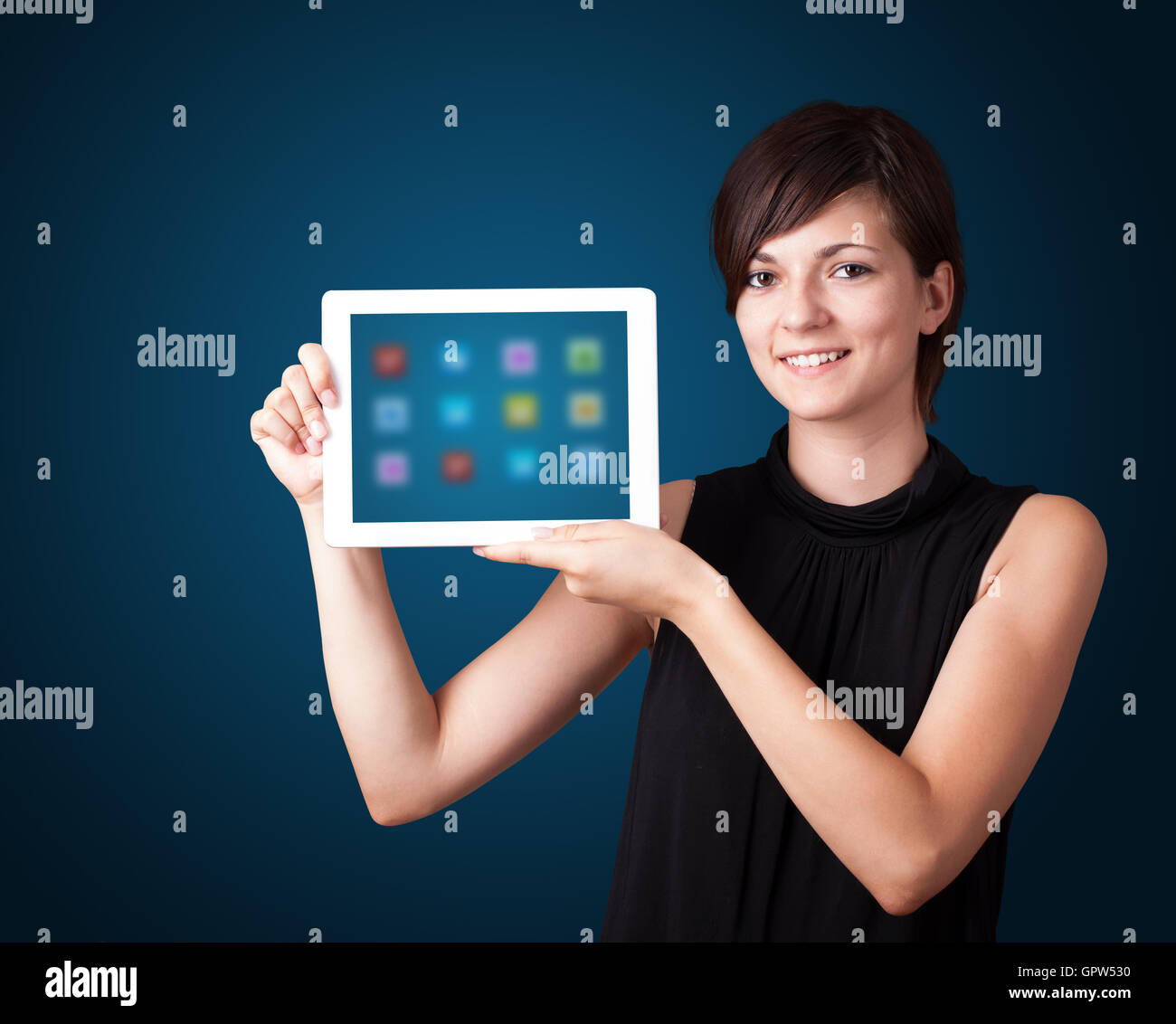 woman holding modern tablet with colorful icons Stock Photo - Alamy
