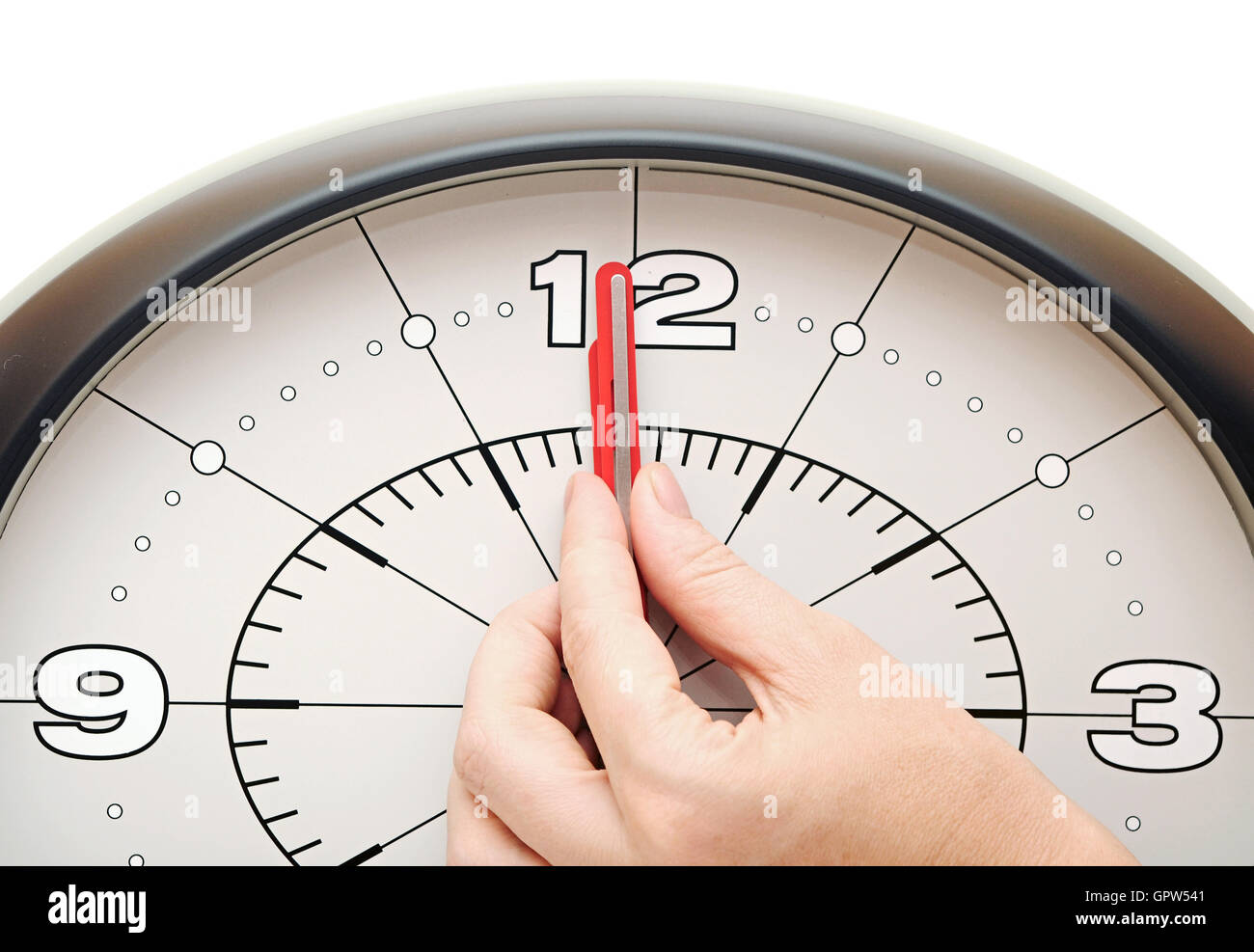 Hand brings hands wall clock showing midnight Stock Photo - Alamy