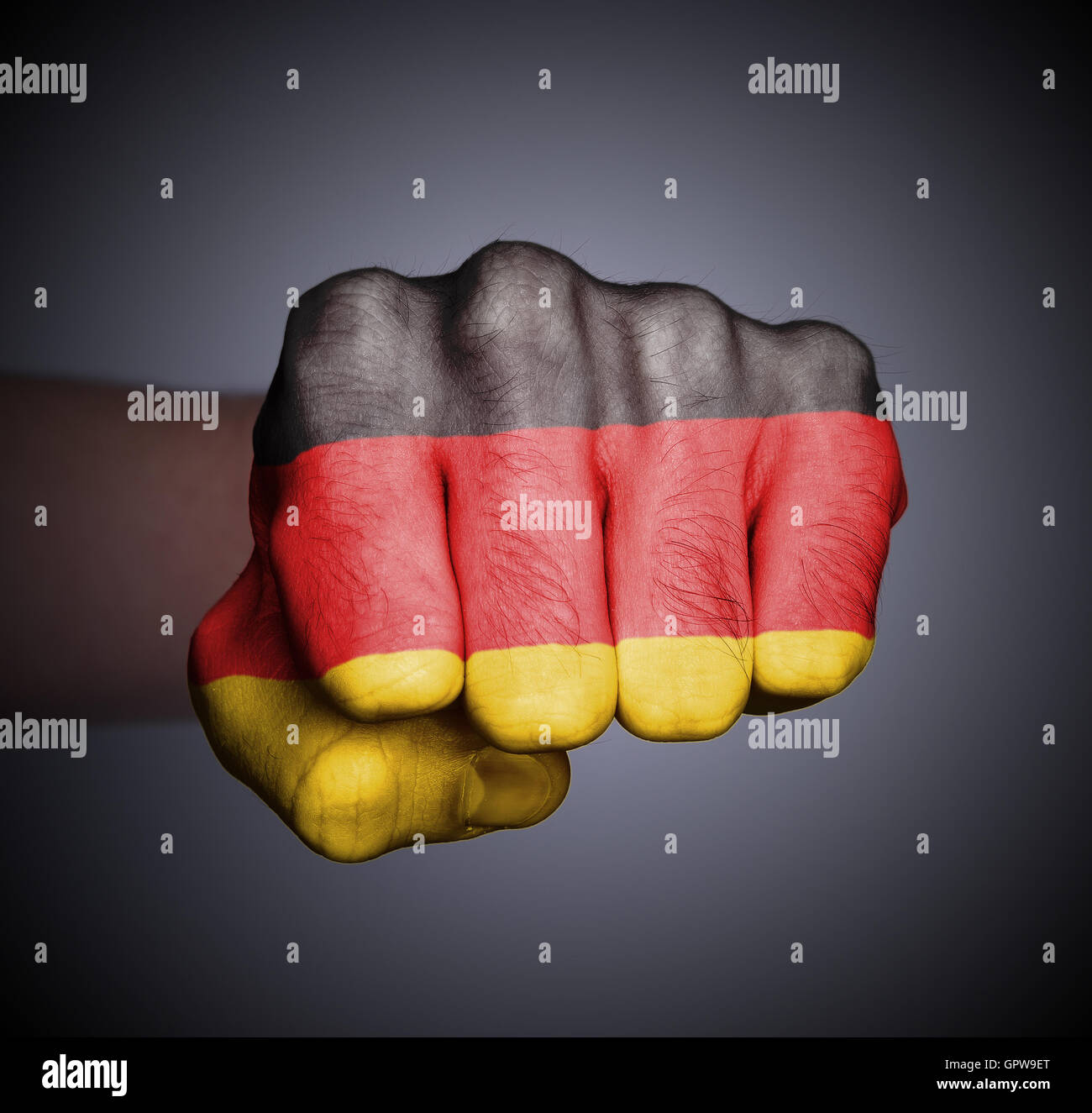 Front view of punching fist on gray background Stock Photo - Alamy